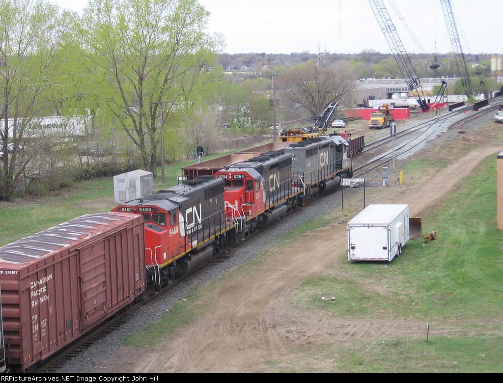 CN "WC Transfer" inches through newly-installed CP switch before crossing over BNSF Northtown ...